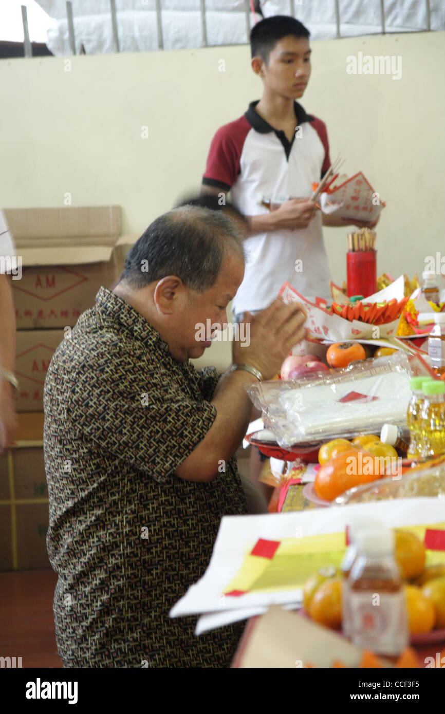 Thai-Chinese people offering prayers at a Chinese temple in Bangkok ...