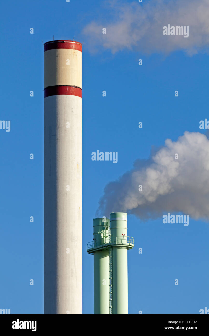 Smoking smokestack with blue sky Stock Photo - Alamy