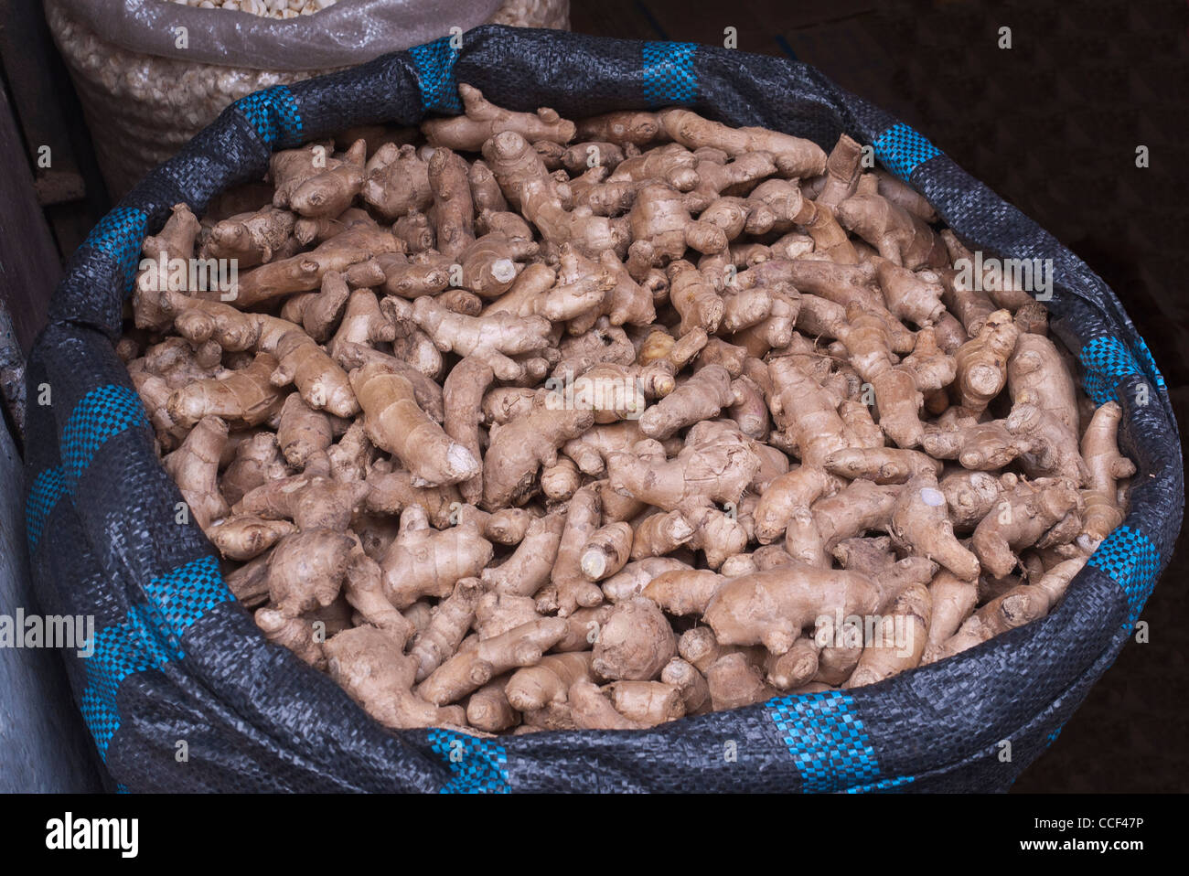 A large barrel full of ginger root on display for sale at a local store ...