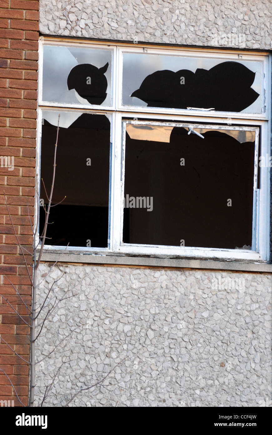 a damaged building with a broken glass window Stock Photo - Alamy