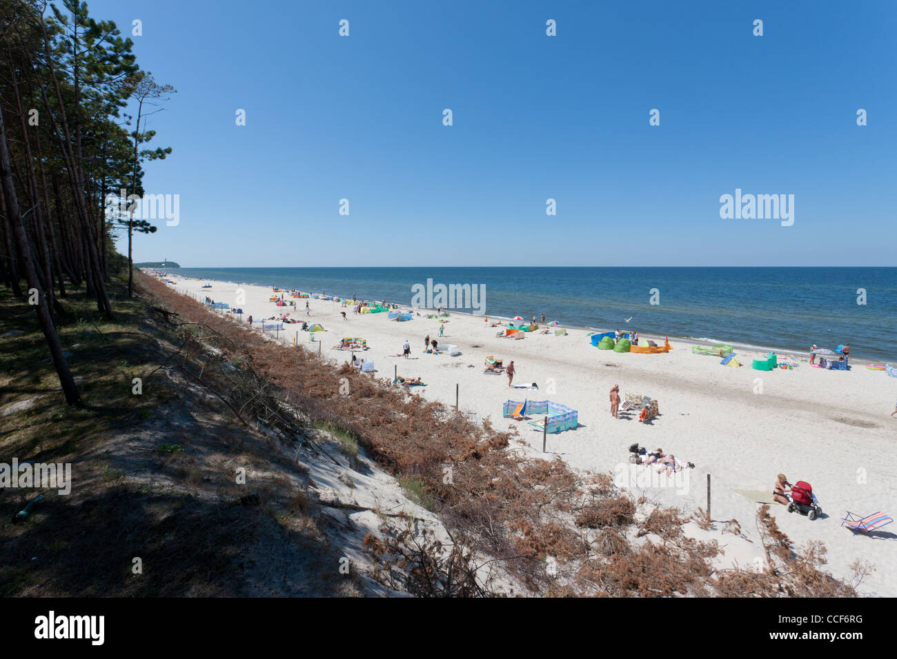 Sandy beach in Pogorzelica. People are sunbathing on the beach ...