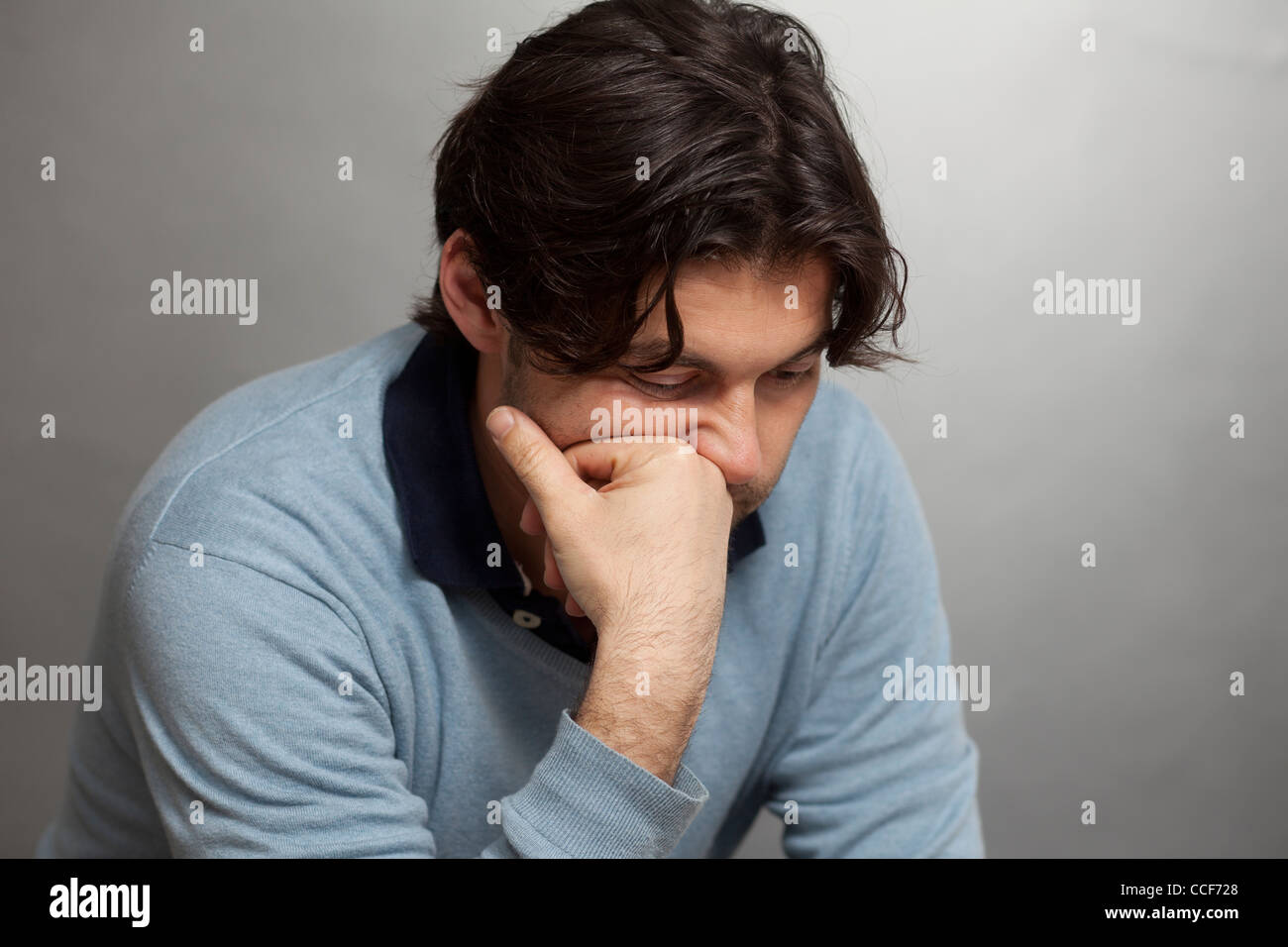 Dark-haired man desperate Stock Photo - Alamy