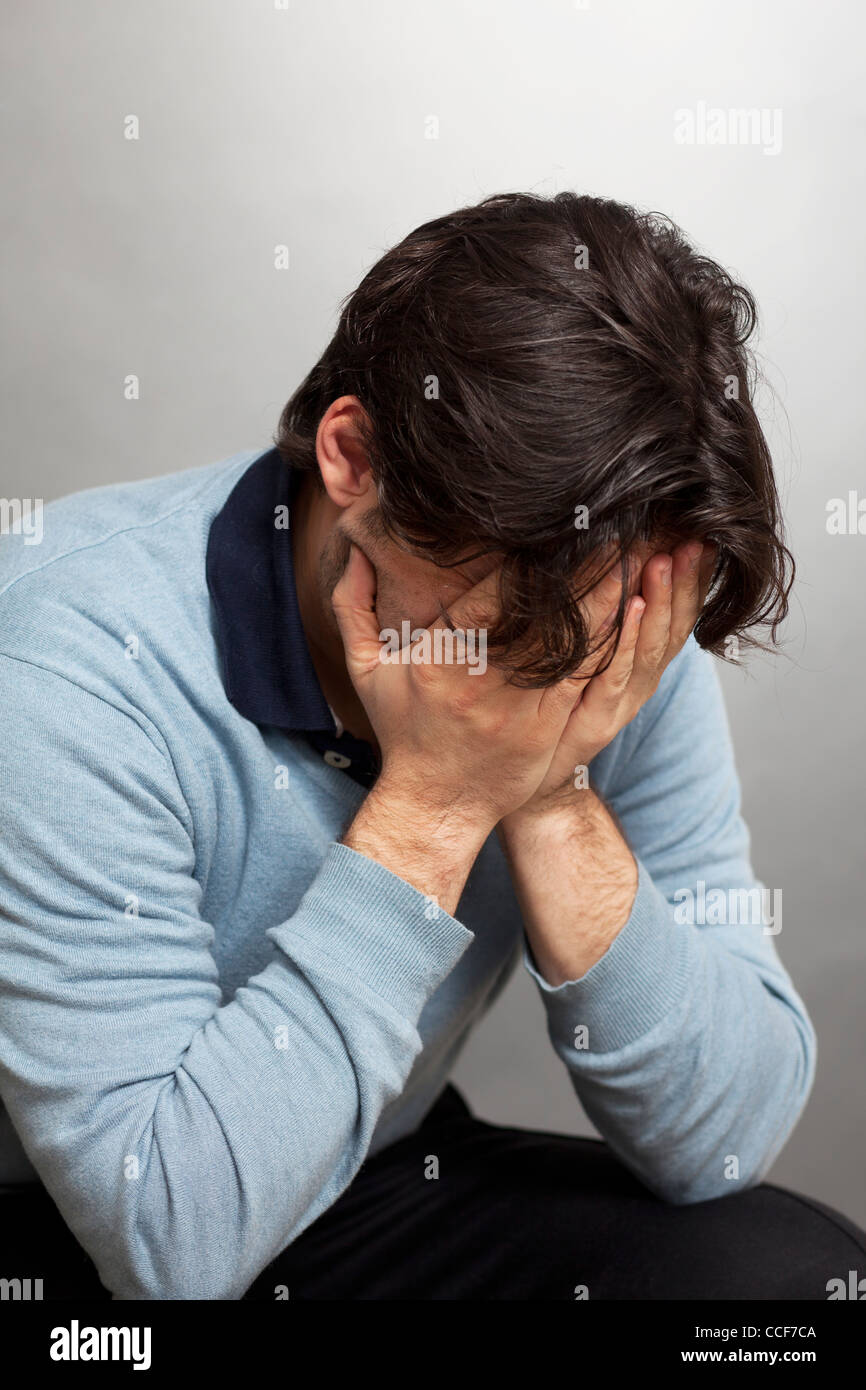 Dark-haired man desperate Stock Photo - Alamy
