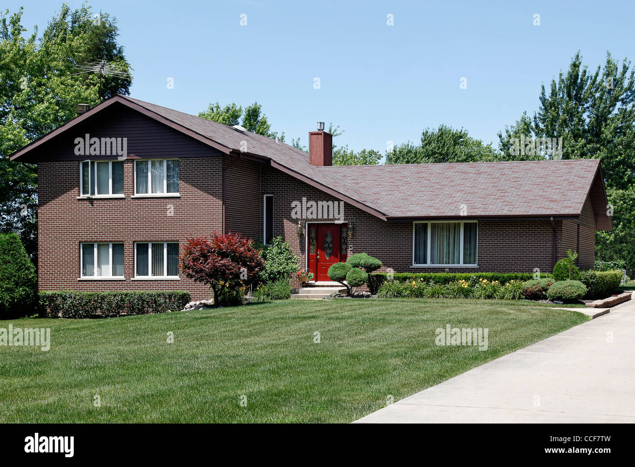 Brick home in suburbs with red door Stock Photo - Alamy