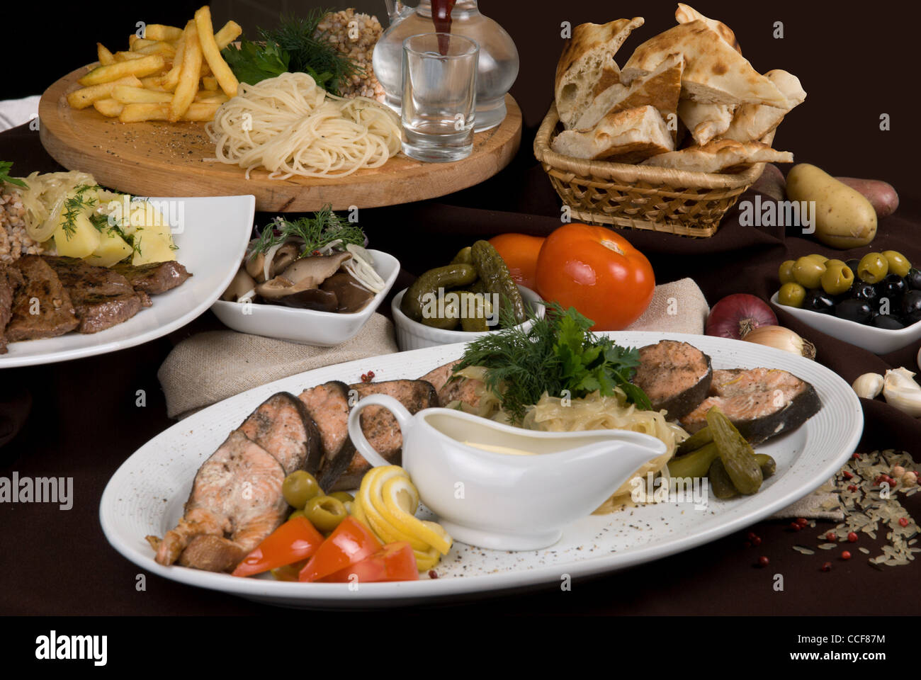 Nosh-up: Many food dishes on the restaurant table Stock Photo - Alamy