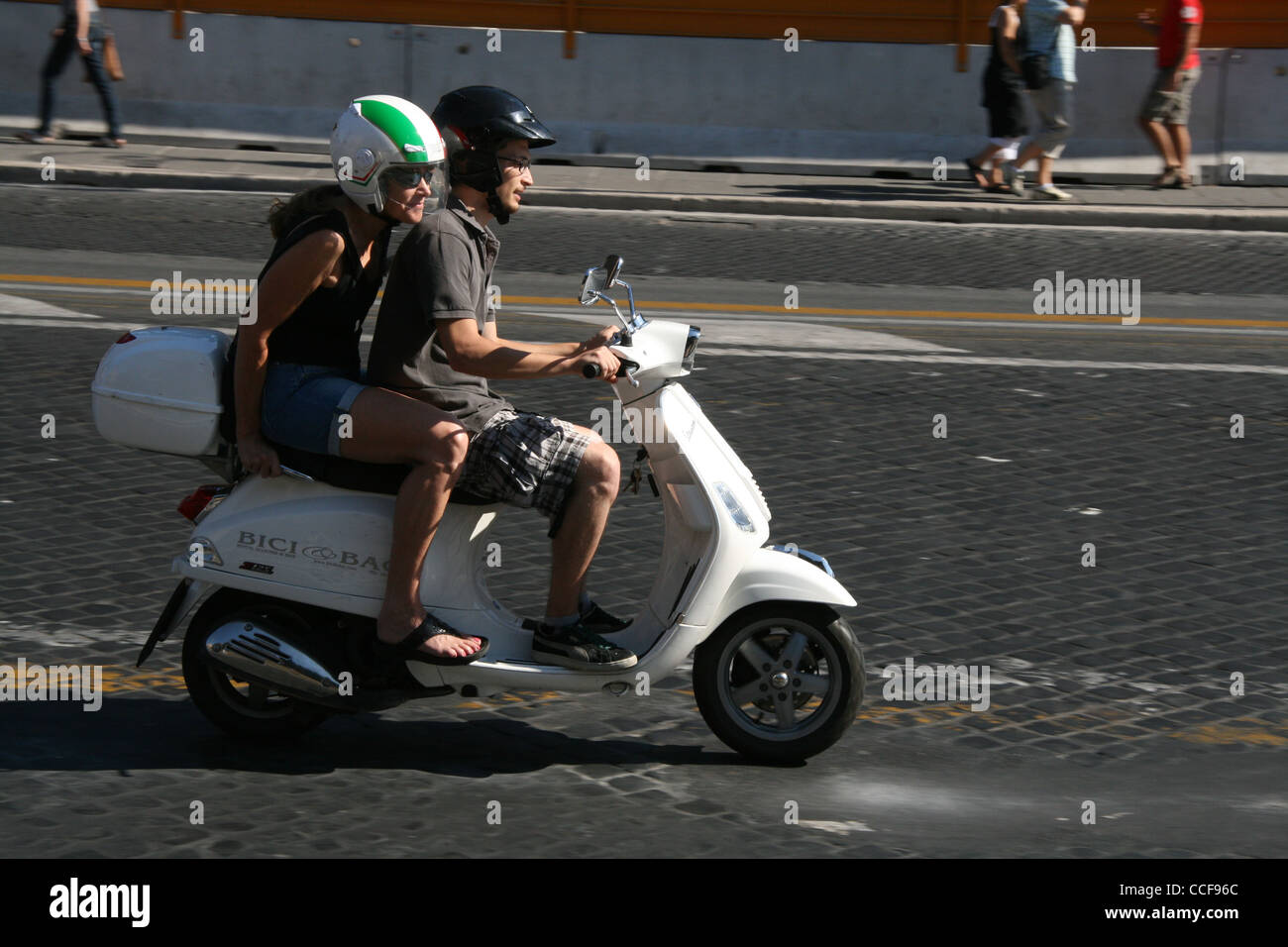 people riding scooter in rome italy Stock Photo - Alamy