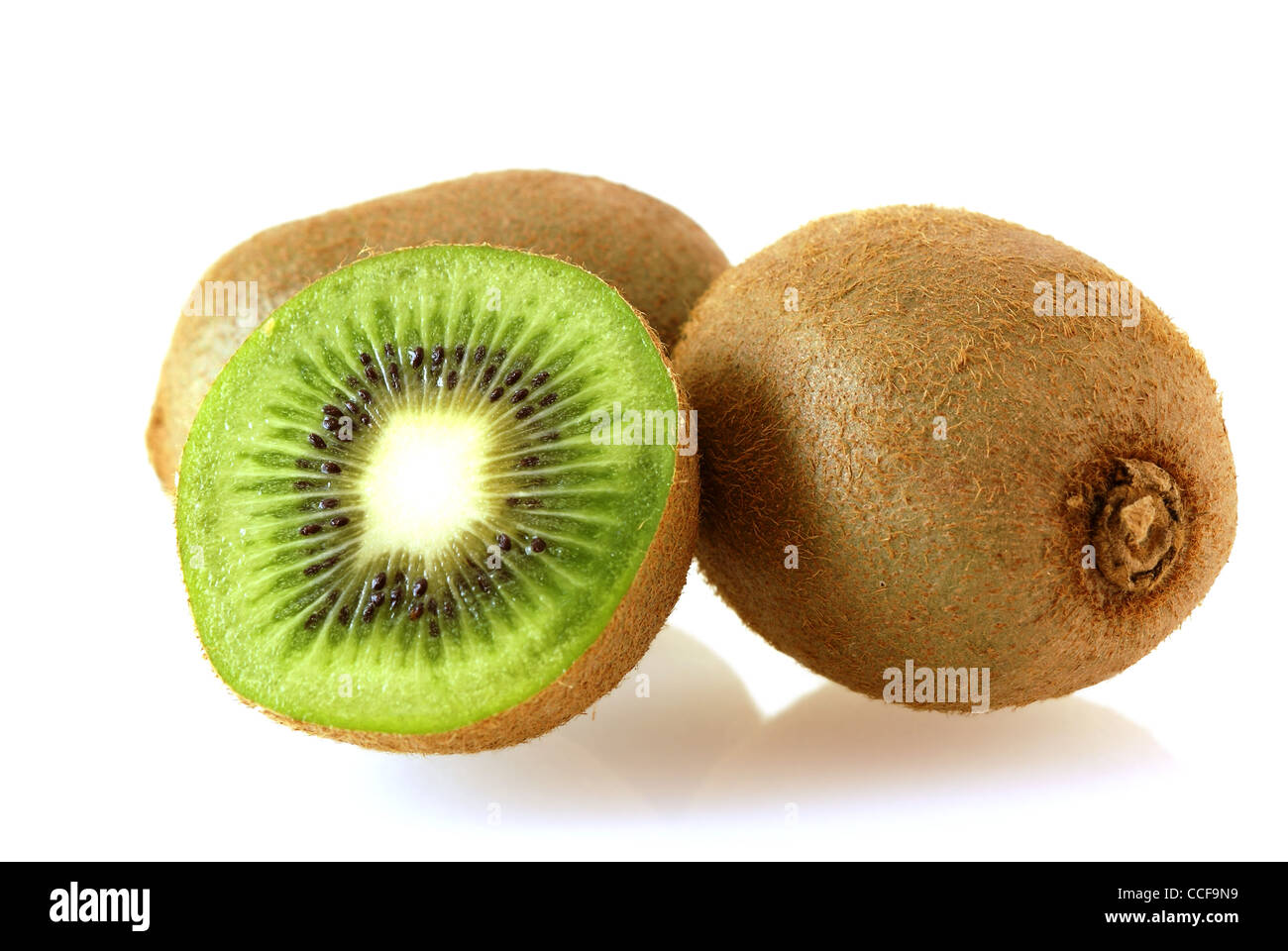 two kiwi fruites with half over white background Stock Photo - Alamy