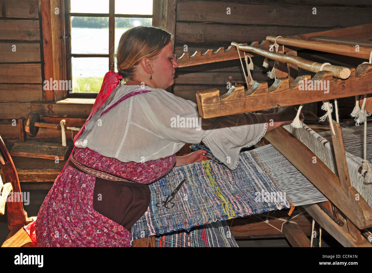 Weaving demonstration with woman in traditional dress hi-res stock ...