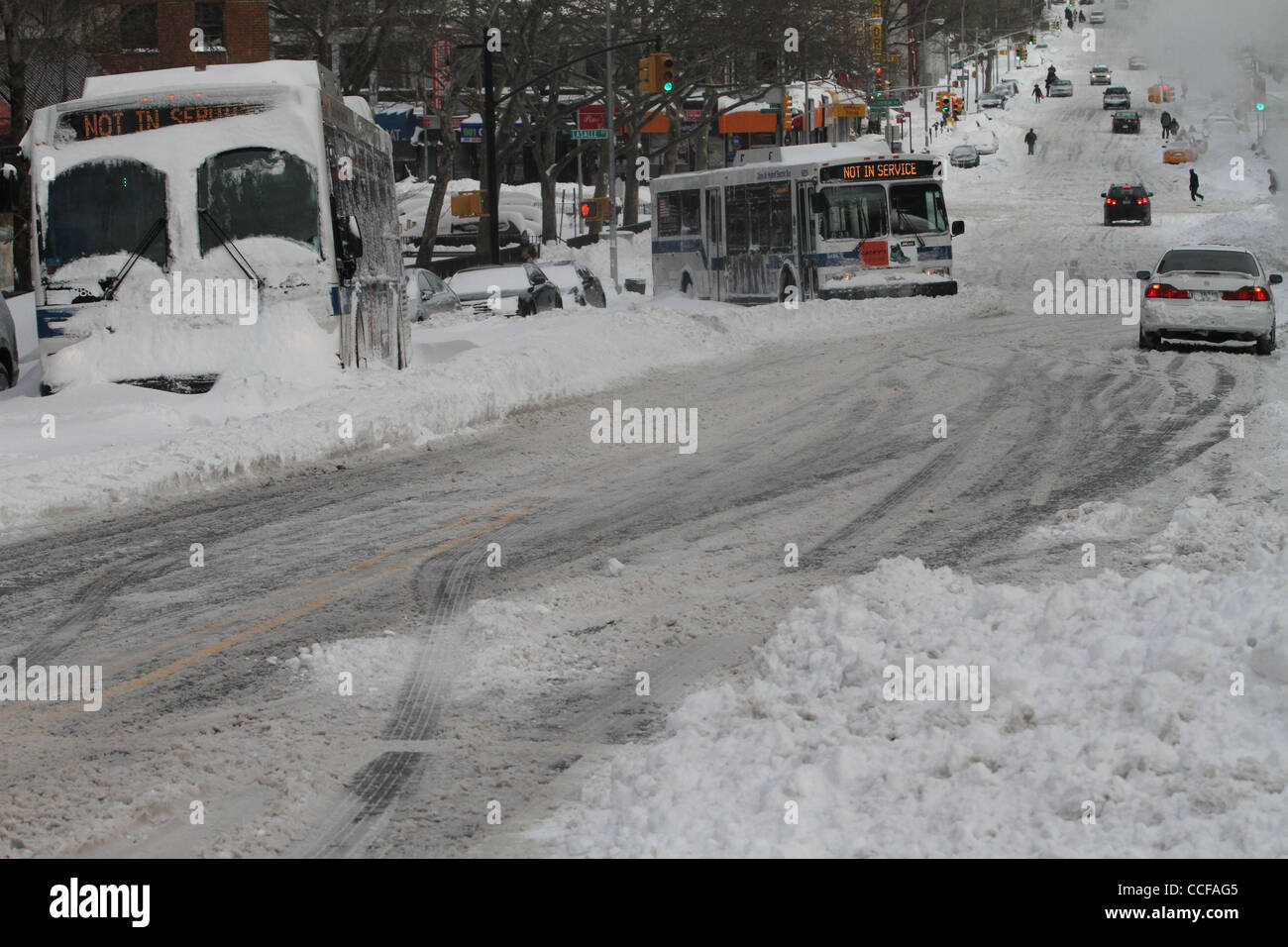Cars trying to get around in the snow, MTA Buses stock in the middle of ...