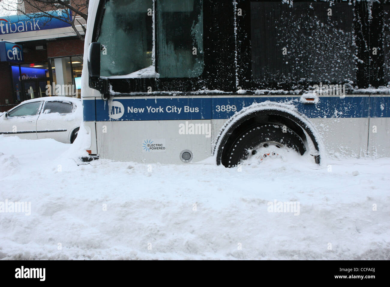 Cars trying to get around in the snow, MTA Buses stock in the middle of ...