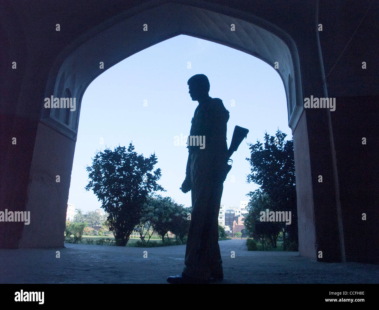 Guard in a park in the heart of crowded Old Dacca in the city of Dhaka ...