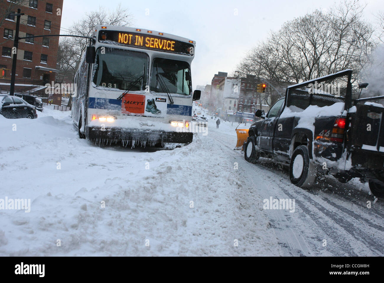 Cars trying to get around in the snow, MTA Buses stock in the middle of ...