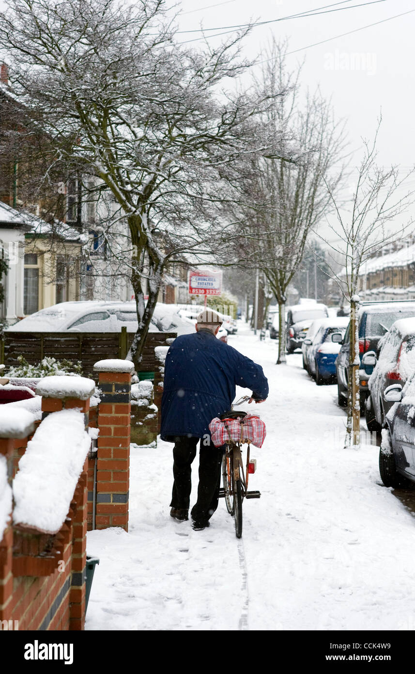 Nov. 30, 2010 - London, United Kingdom - A man walking in the snow in ...