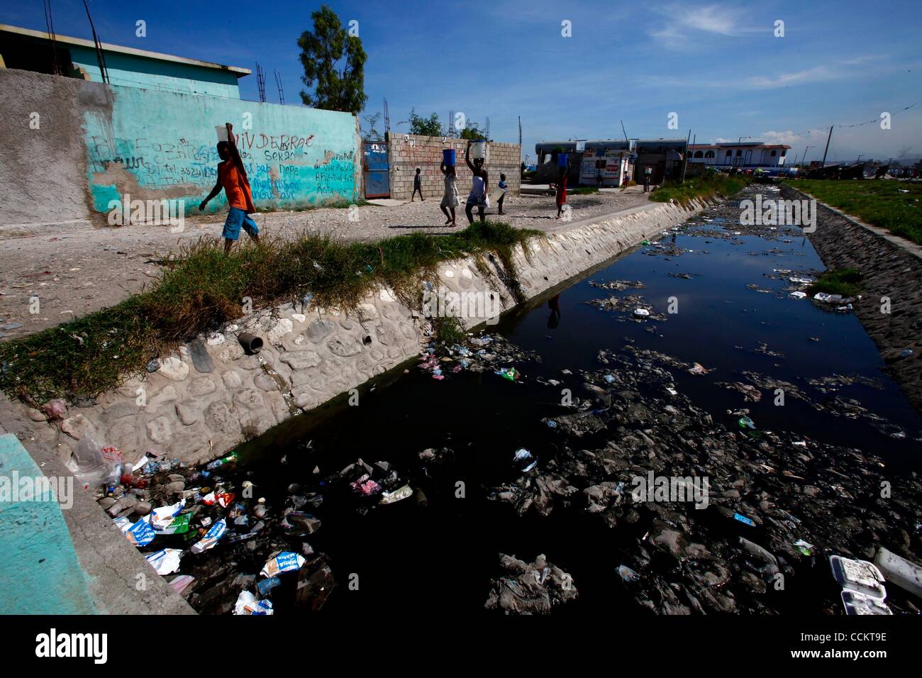 Nov. 10, 2010 - Port-au-Prince, Haiti - Residents carry water gathered ...