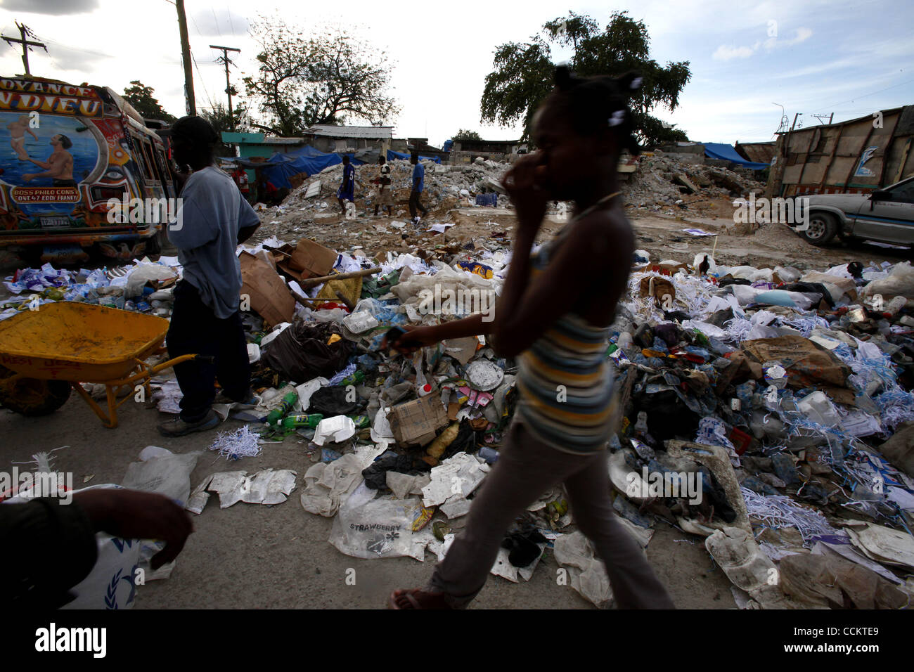 Nov 10, 2010 - Port-au-Prince, Haiti.Residents walk by large piles of ...