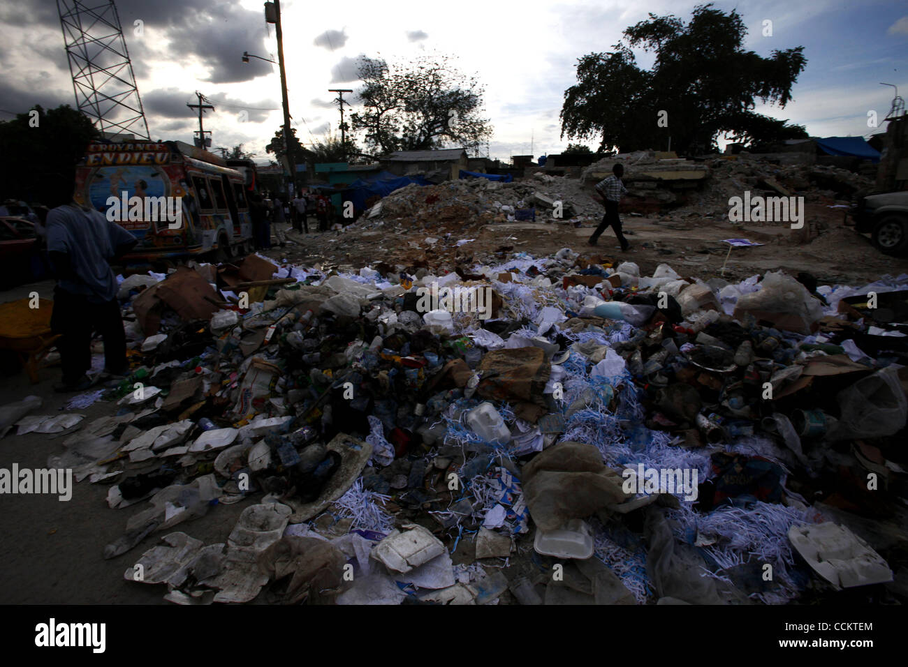 Nov 10, 2010 - Port-au-Prince, Haiti.Residents walk by large piles of ...