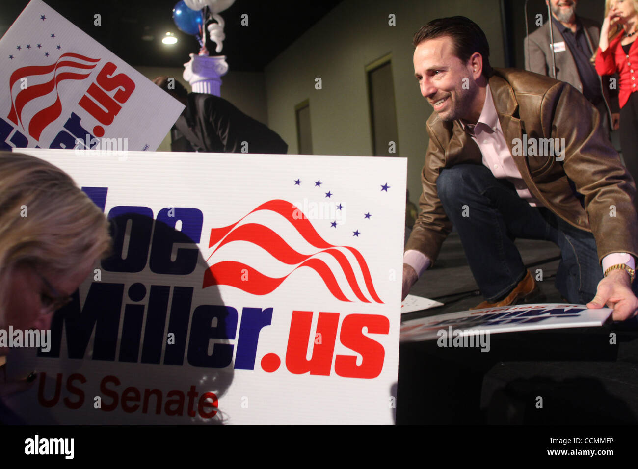 Republican Senate and Tea Party candidate Joe Miller signs posters ...