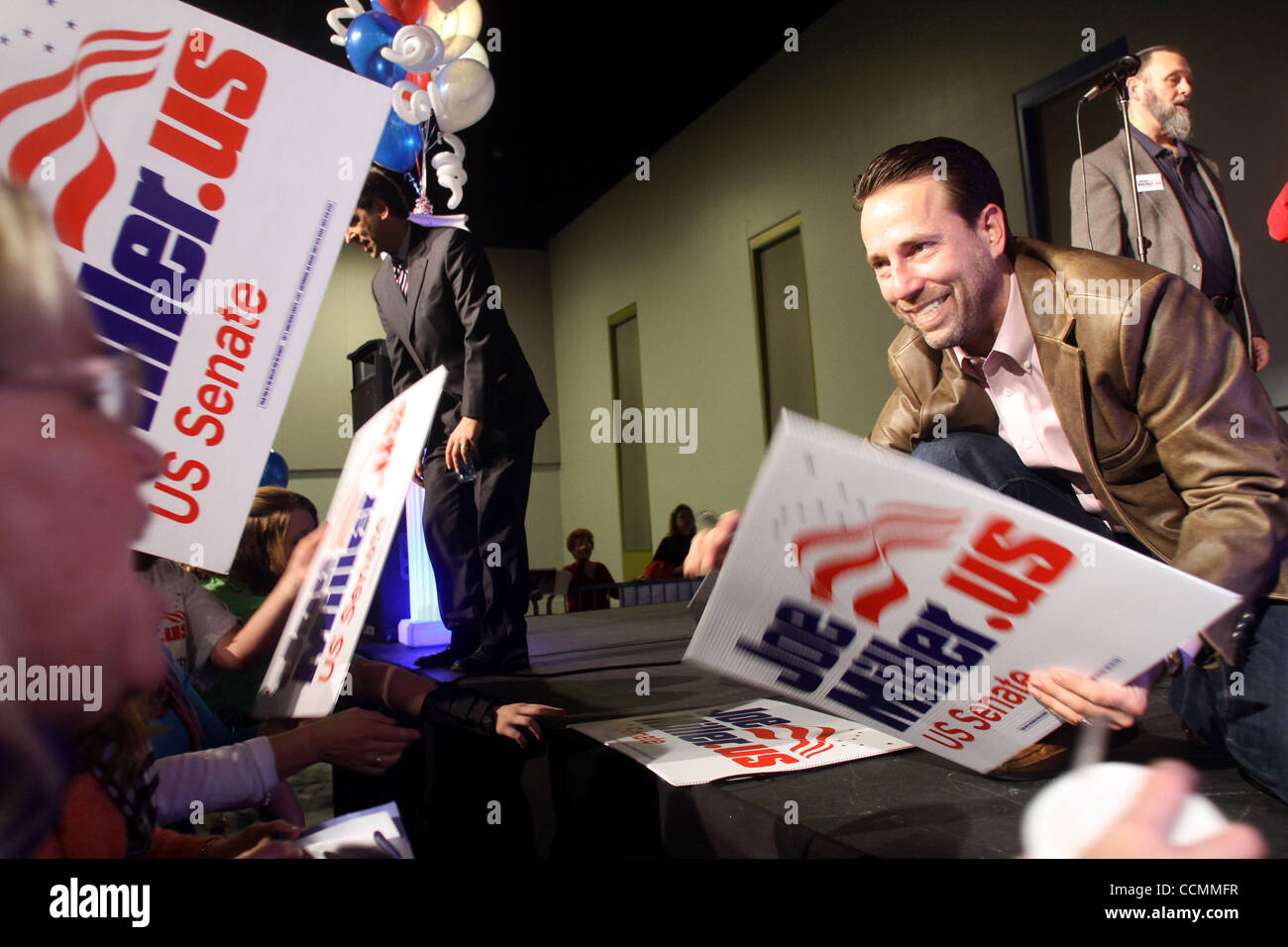Republican Senate and Tea Party candidate Joe Miller signs posters ...