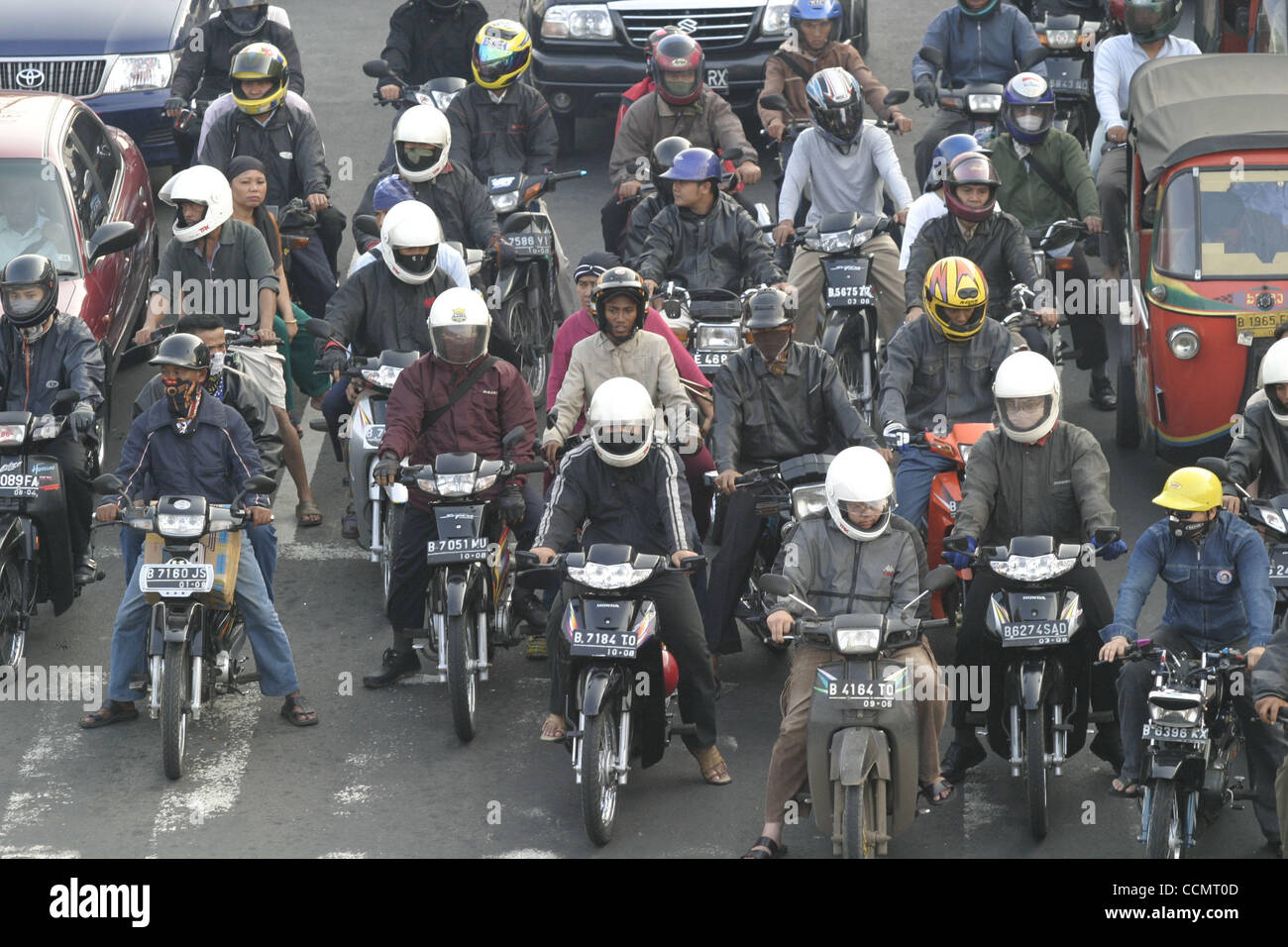 JAKARTA, INDONESIA - JUNE 17, 2004 Motorcycle riders waiting for green ...