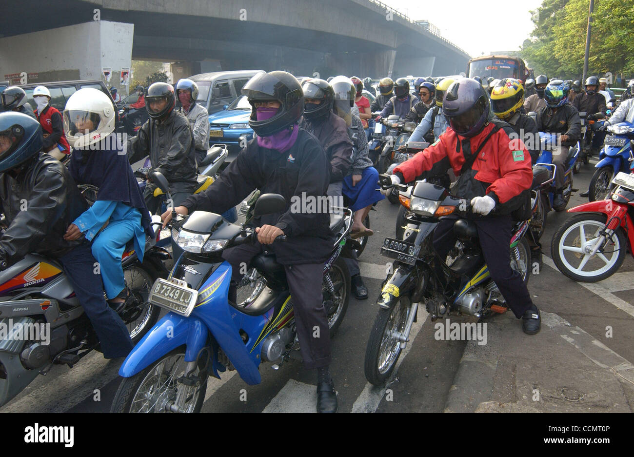 JAKARTA, INDONESIA-JUNE 16, 2004 Motorcycle riders in the mid of ...