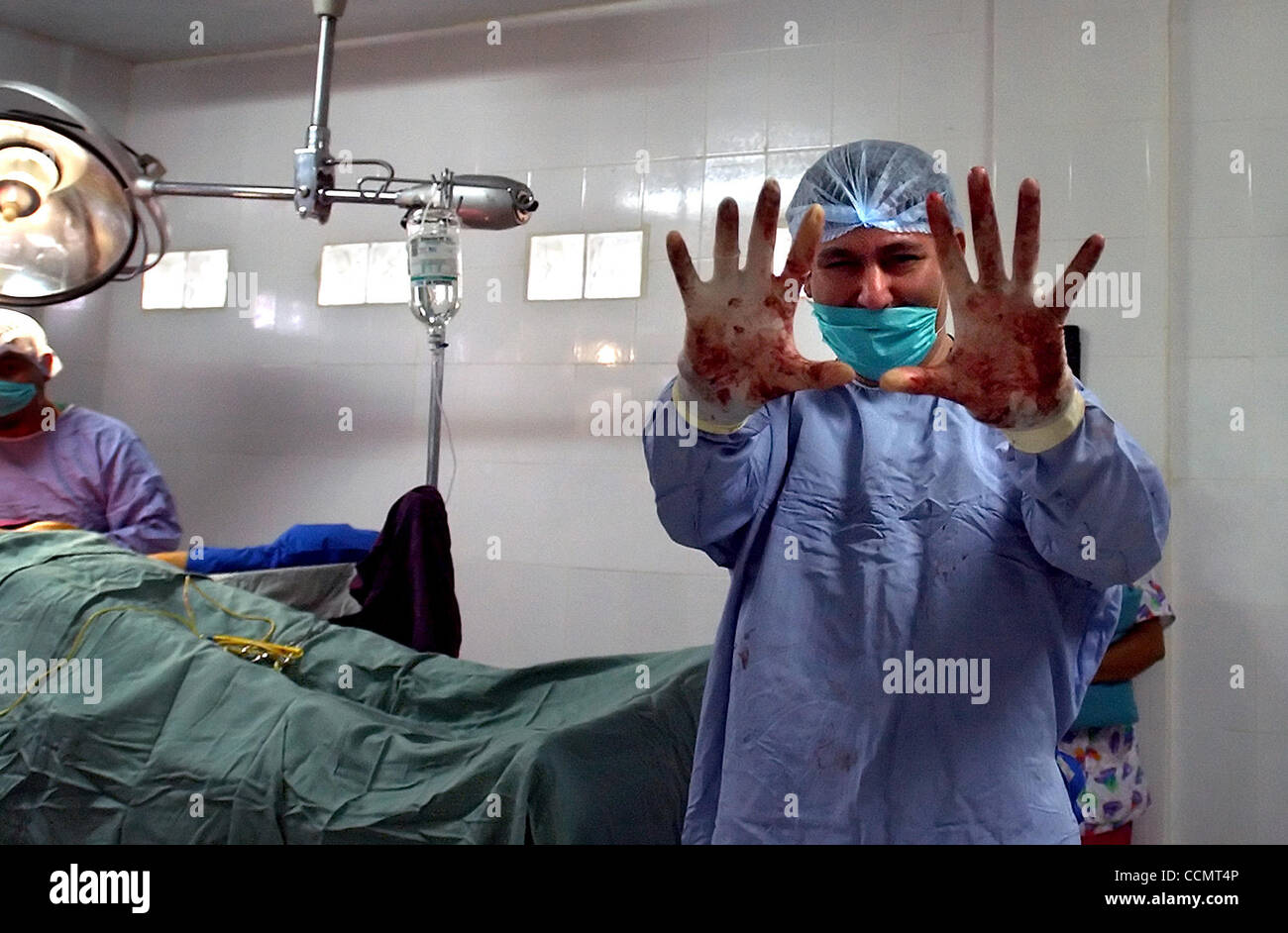 Dr. Jose Luis Villarreal Arroyo shows off his bloody gives in the ...