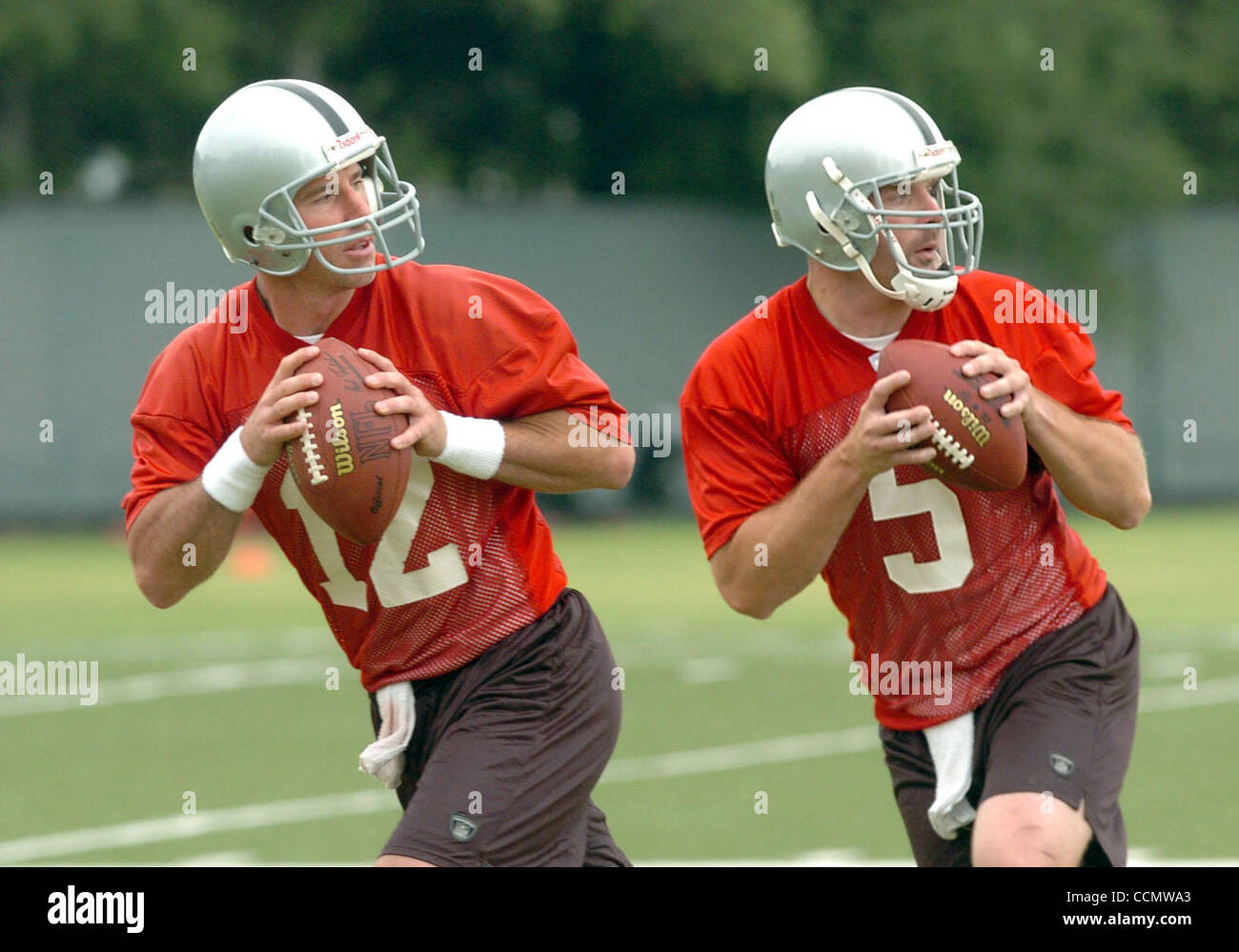 Quarterbacks Rich Gannon, left, and Kerry Collins, right, drop back to ...