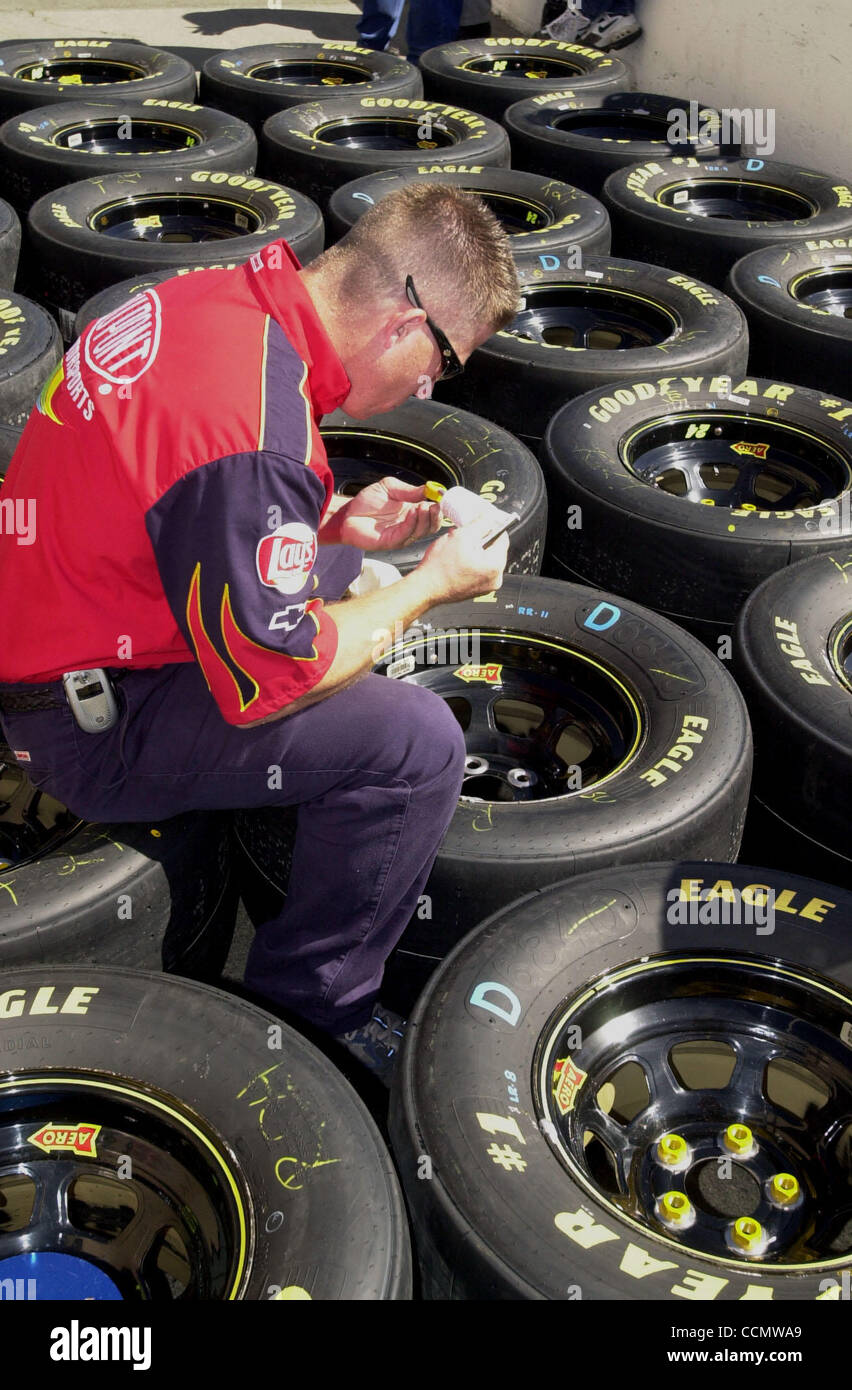 Ryan Pepe, crew member for Jeff Gordon, applies weather stripping to ...