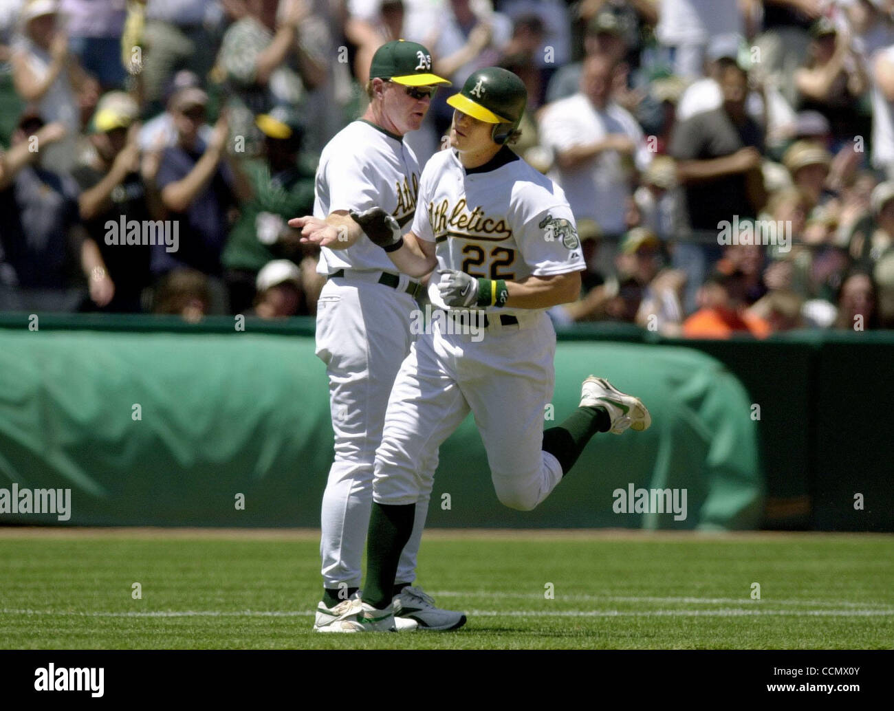 Eric Byrnes of the Oakland A's rounds third base after hitting his ...