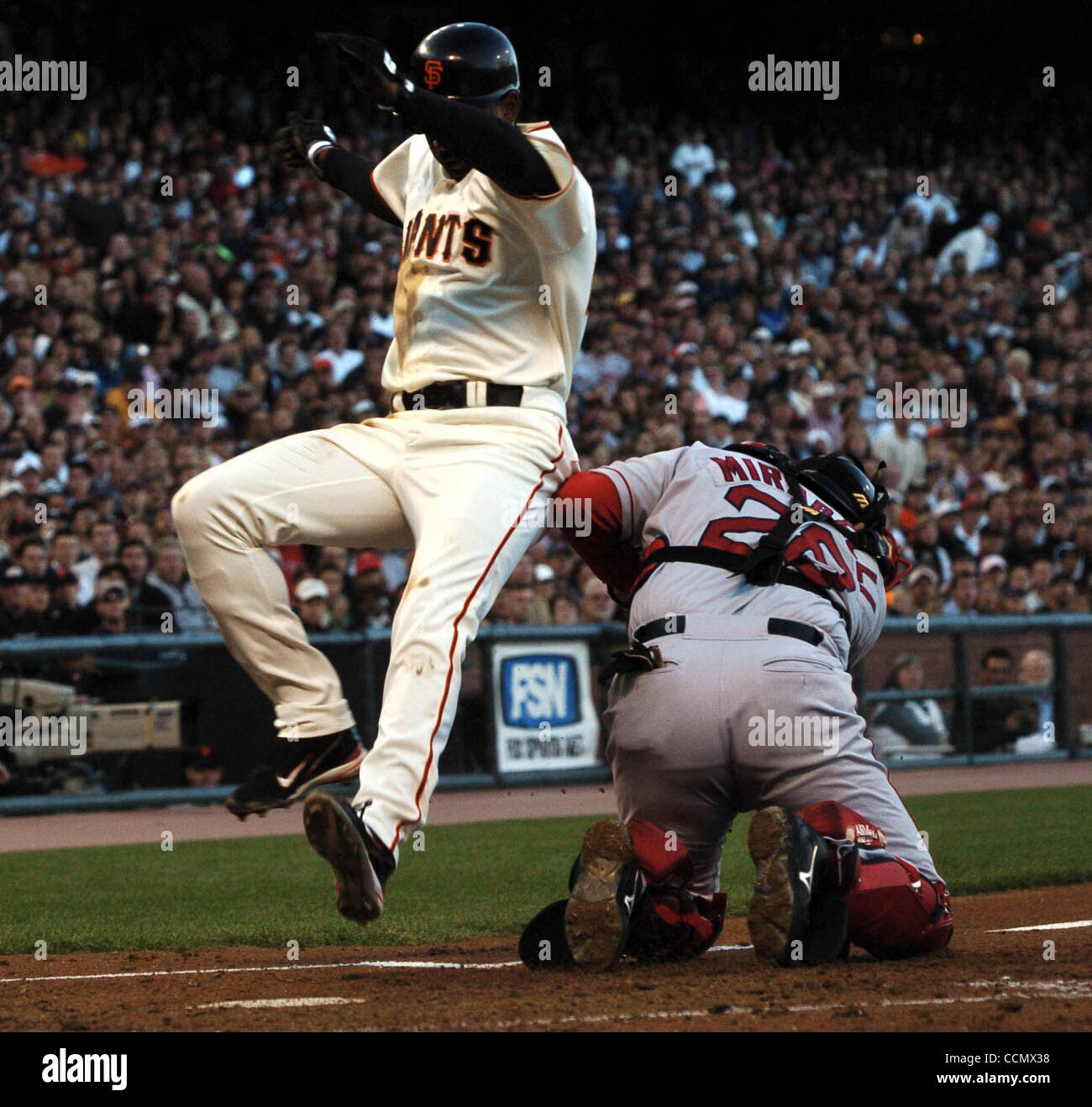 Michael Tucker of the San Francisco Giants comes in for a safe landing ...