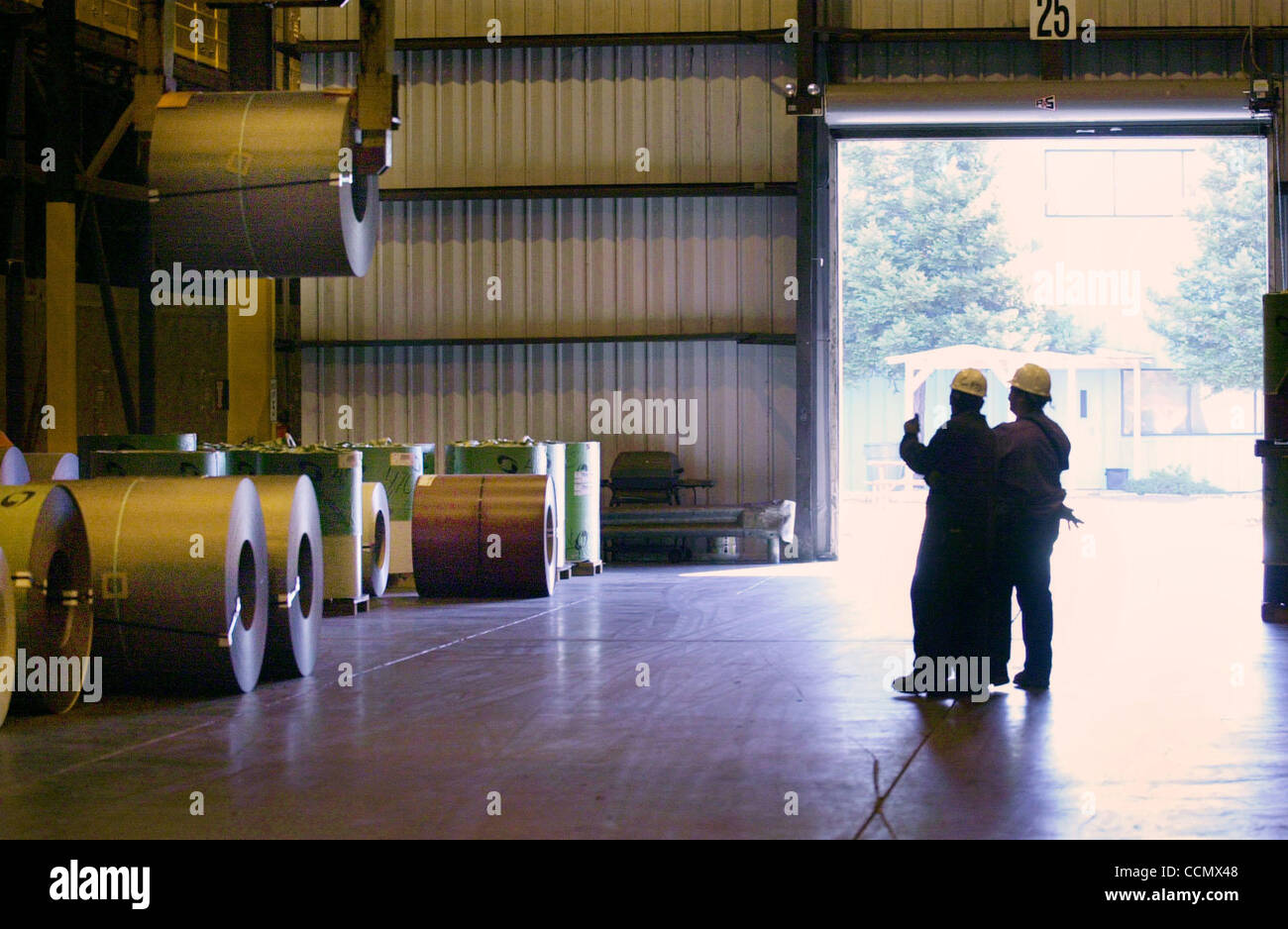 Workers at Steelscape in Richmond, Calif., move a 16,000-pound roll of ...