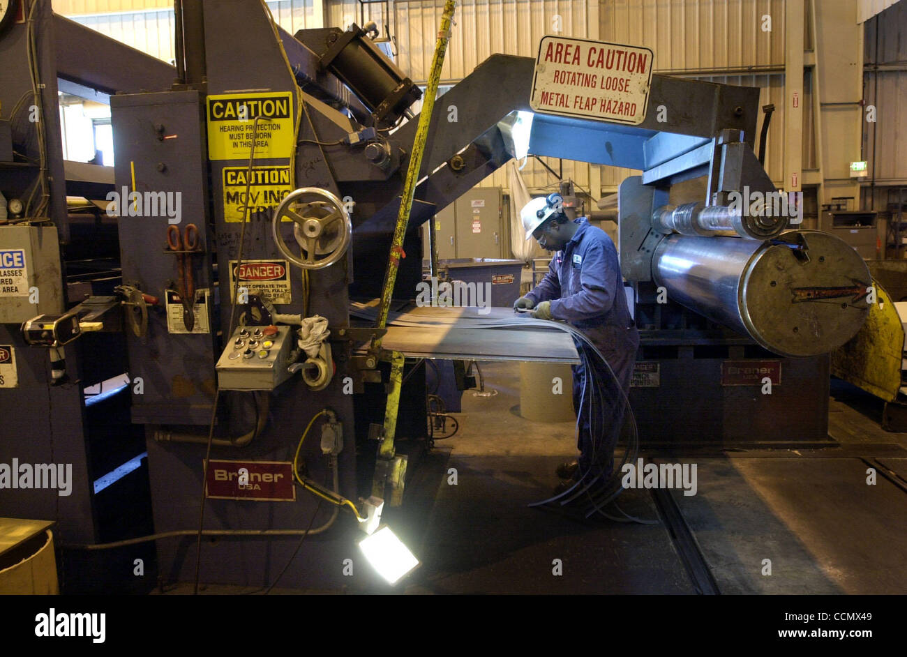 Rudy Bacon checks the width of steel coming through the slitting line ...