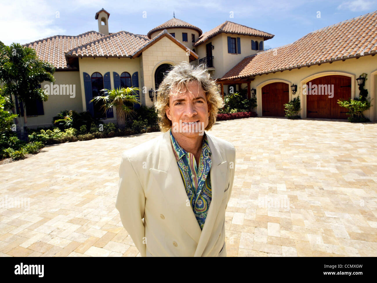 MANALAPAN; 7/2/04: Frank McKinney outside one of his oceanfront spec ...