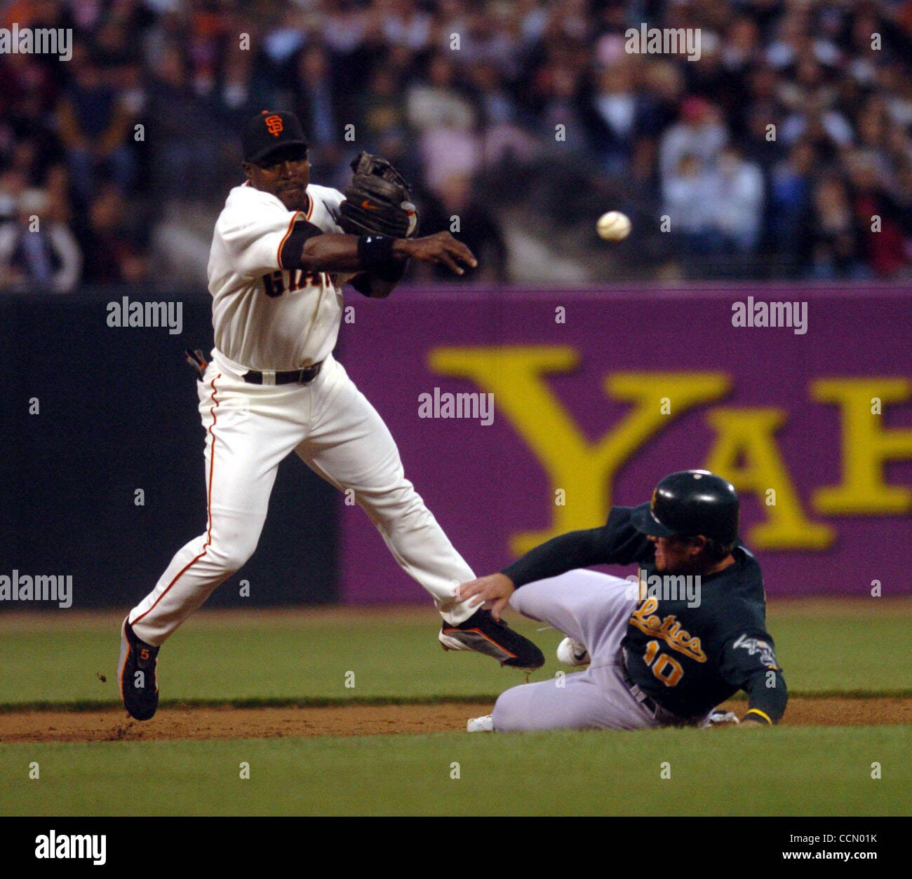 Giants second baseman Ray Durham (cq)(left) throws to first as A's ...