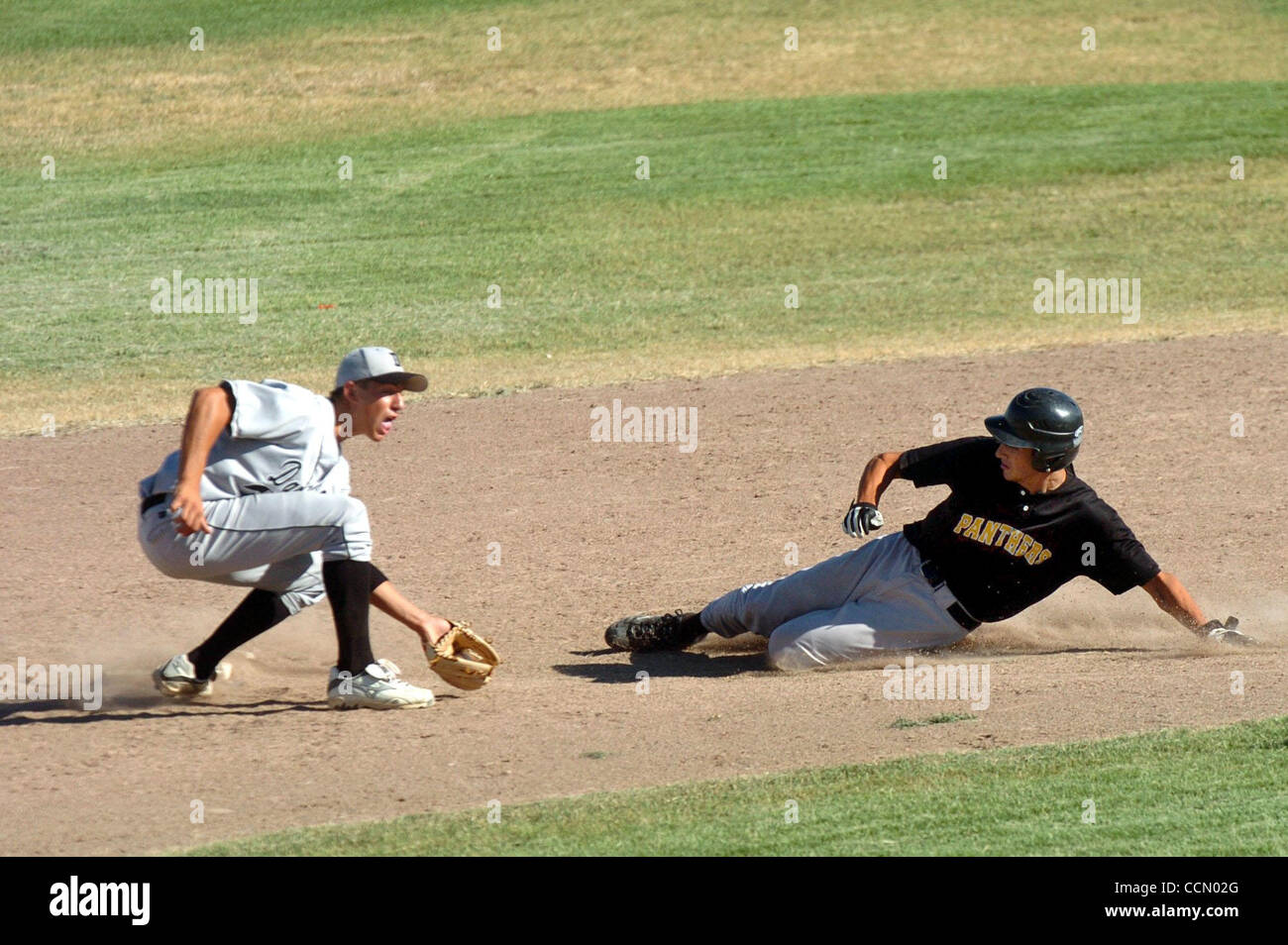 Antioch's Dillon Long (cq)(right) slides safely into second base while ...
