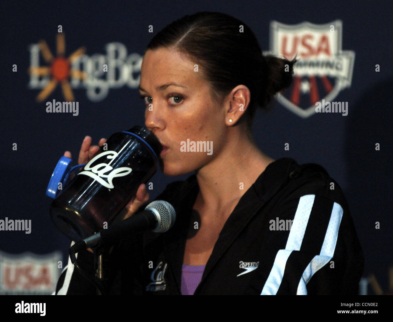 Taking a swig from a Cal water bottle, Natalie Coughlin held a press ...