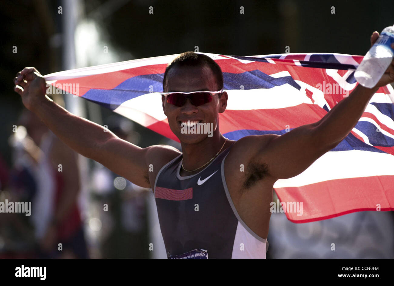 Carrying the flag of his native state, Hawaii, Bryan Clay celebrates ...