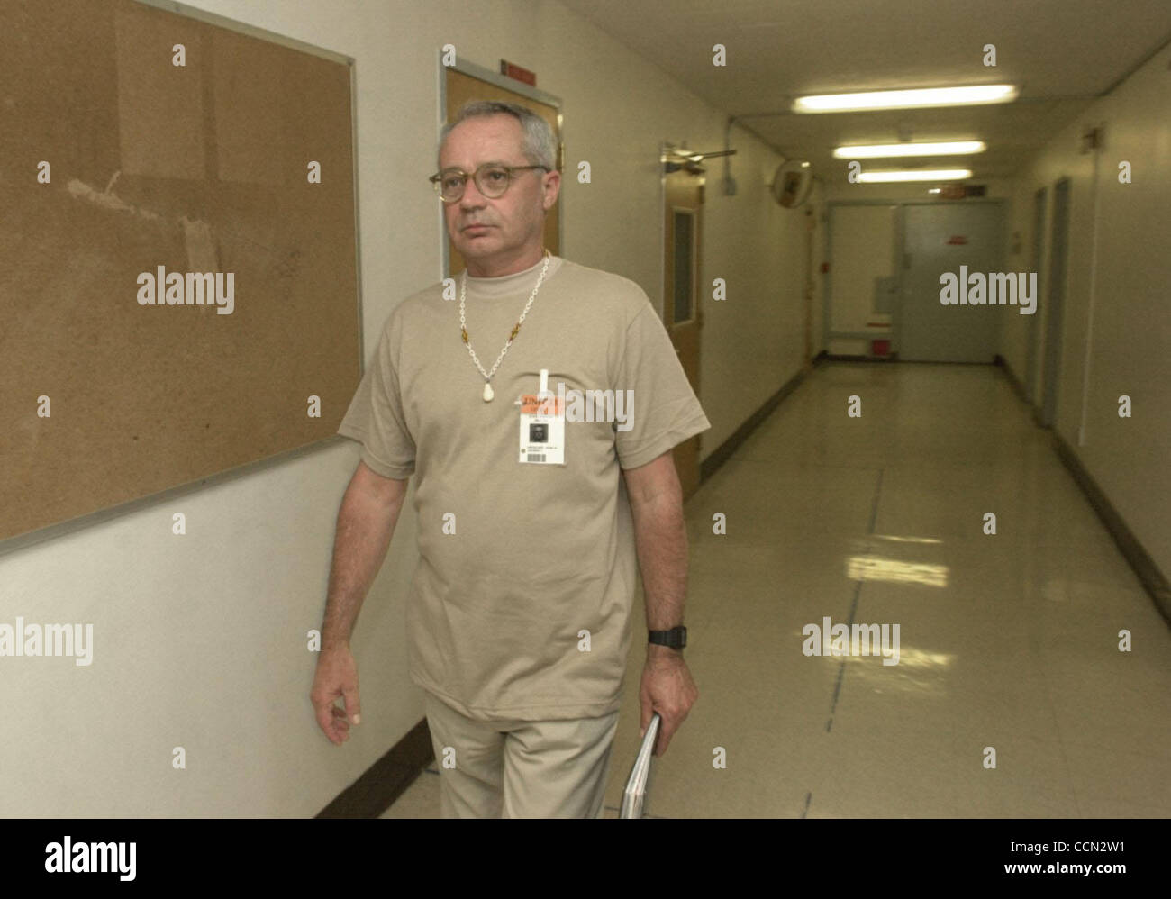 John Kreischer 58, of San Diego, Calif., walks down a hallway at the ...
