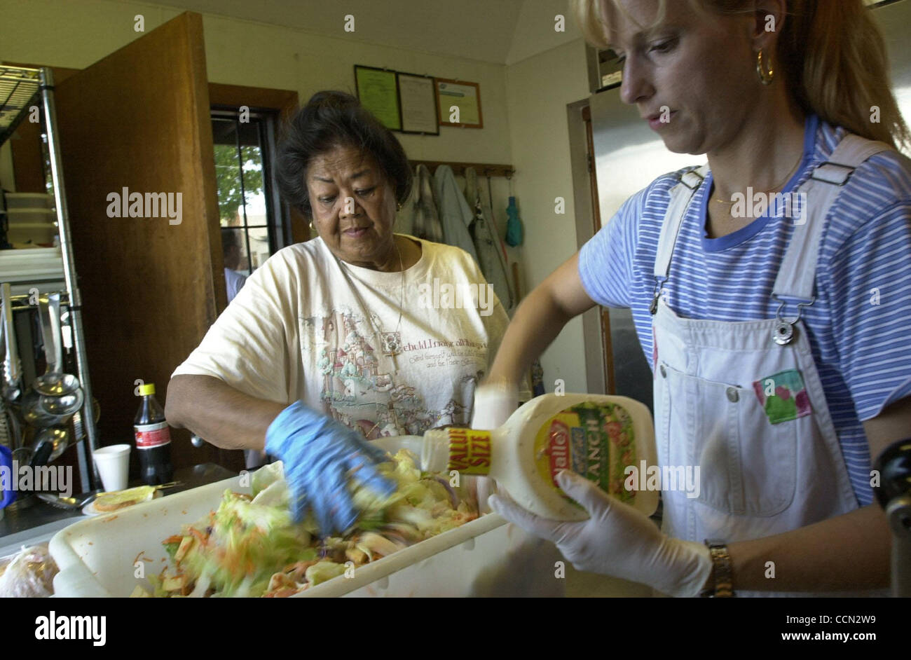 Volunteers Marcela Darling, left, and Keri Phillips, right, both of ...
