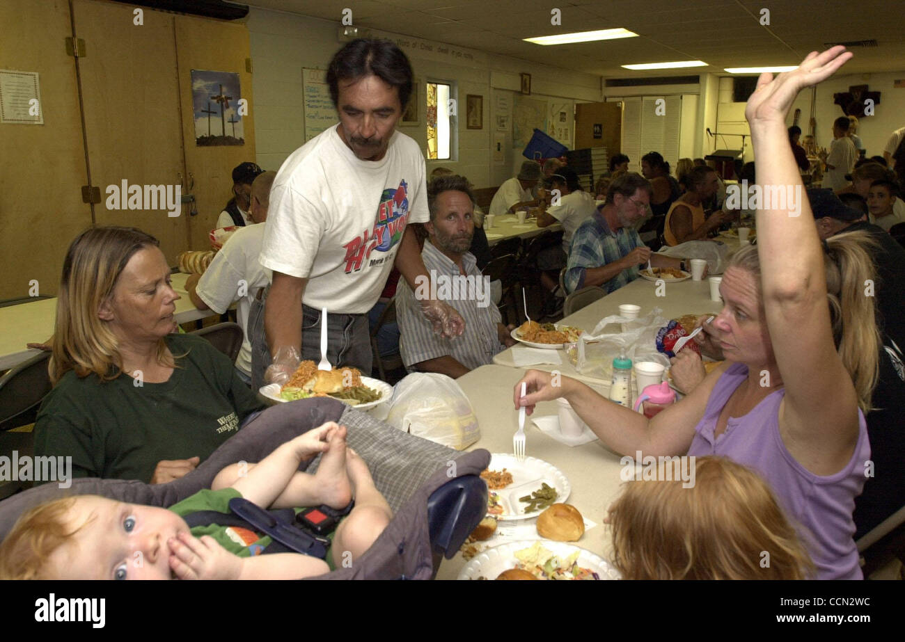 Volunteer Brian Tapia, of Antioch, hands a dinner plate to Sharon ...