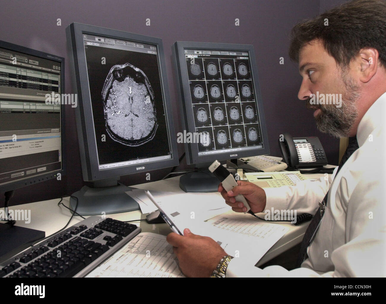 Adrian Riggs a clinical PACS advisor is busy testing the "PACS," a ...