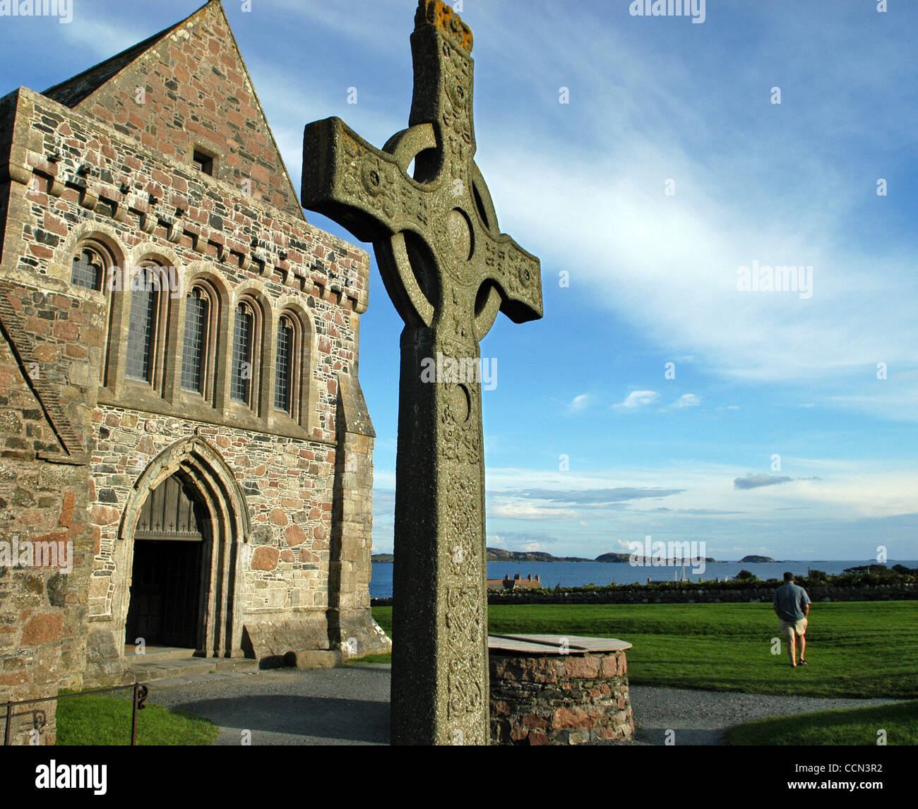 A tall Celtic cross stands majestically outside Iona Abbey on tiny Isle ...