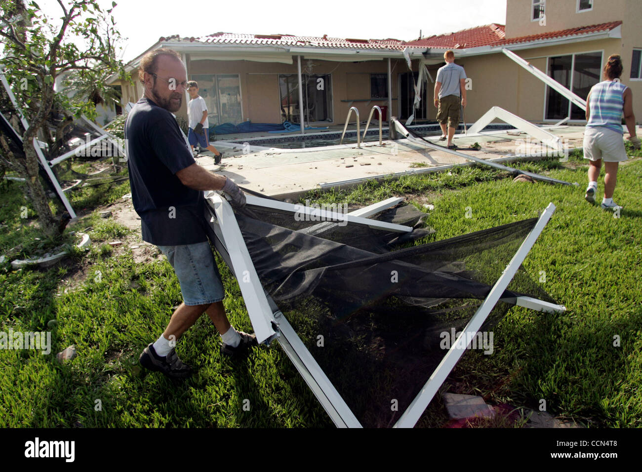 Jesse Boyd removes his pool enclosure from their hurricane-damaged ...