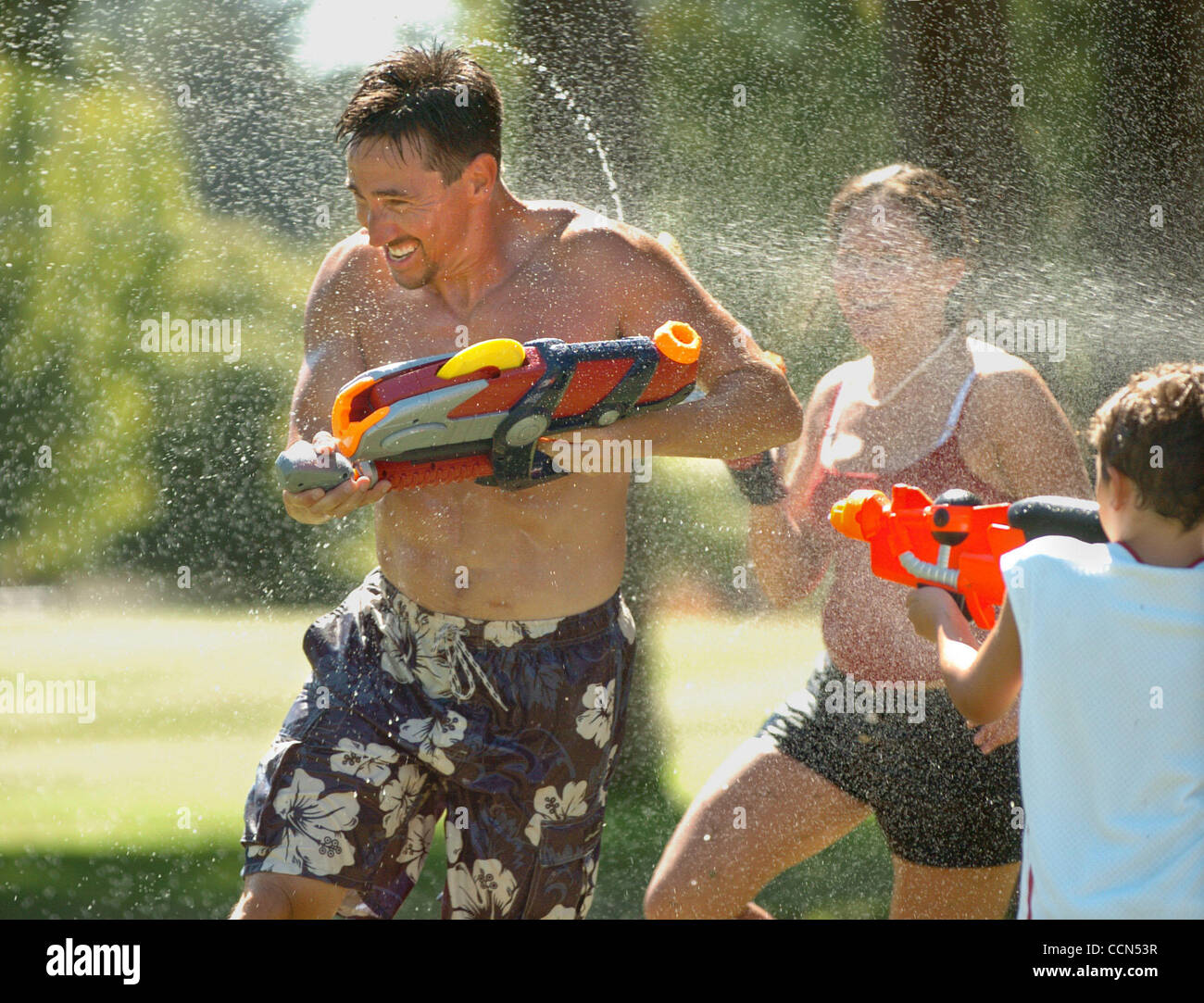 Paul Hernandez is chased by his daughter Audrey Hernandez, 13, center ...