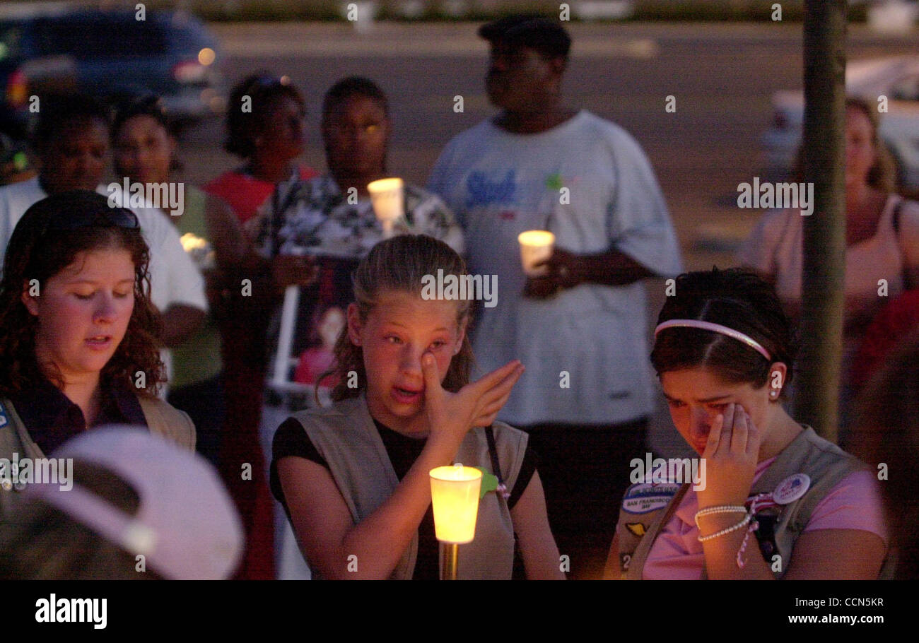 Girl scouts wipe their tears during a candlelight vigil for Ariana ...