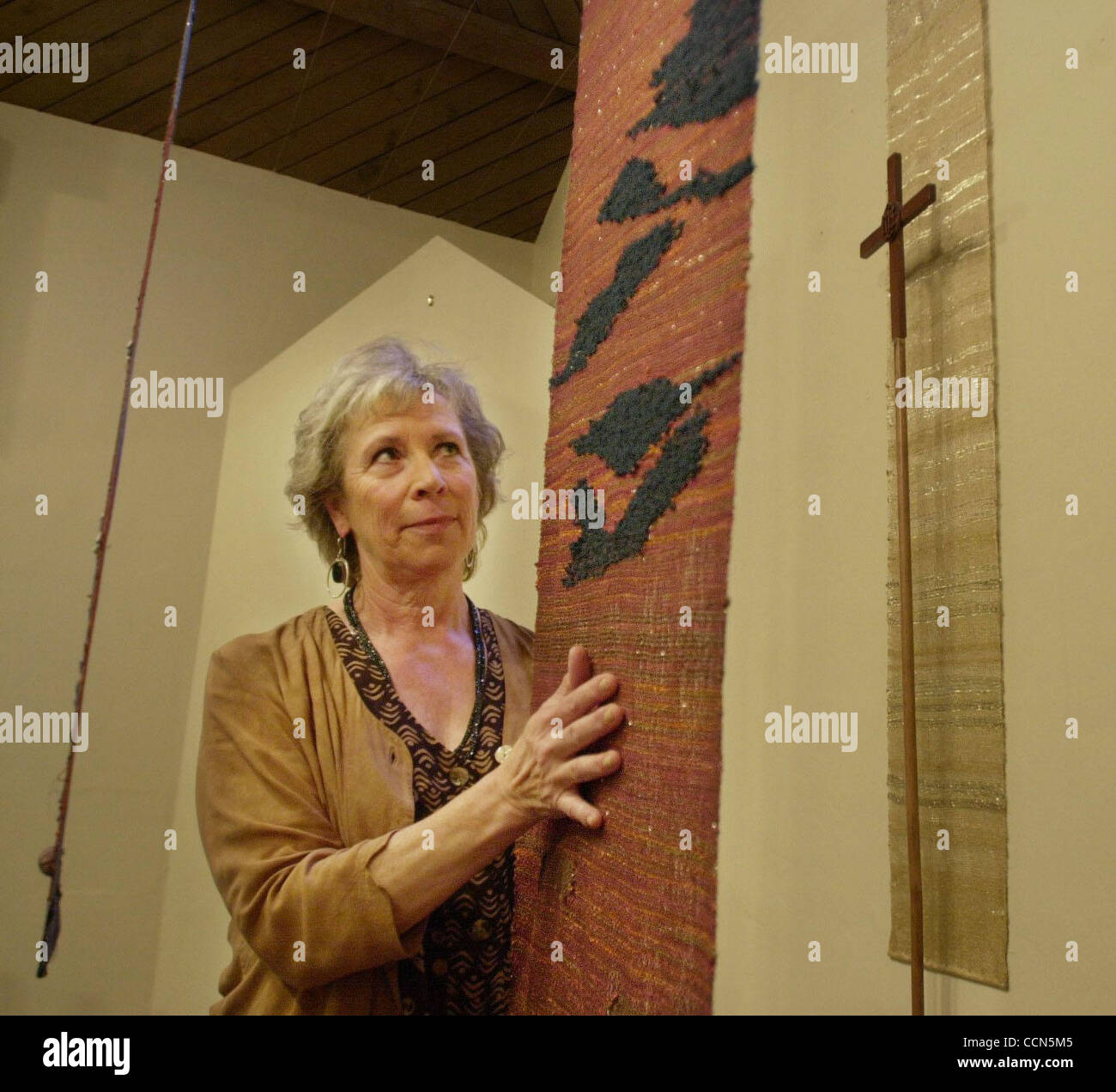 Pastor Mary Rowe (cq) looks over a 9-foot-long tapestry she wove, which ...