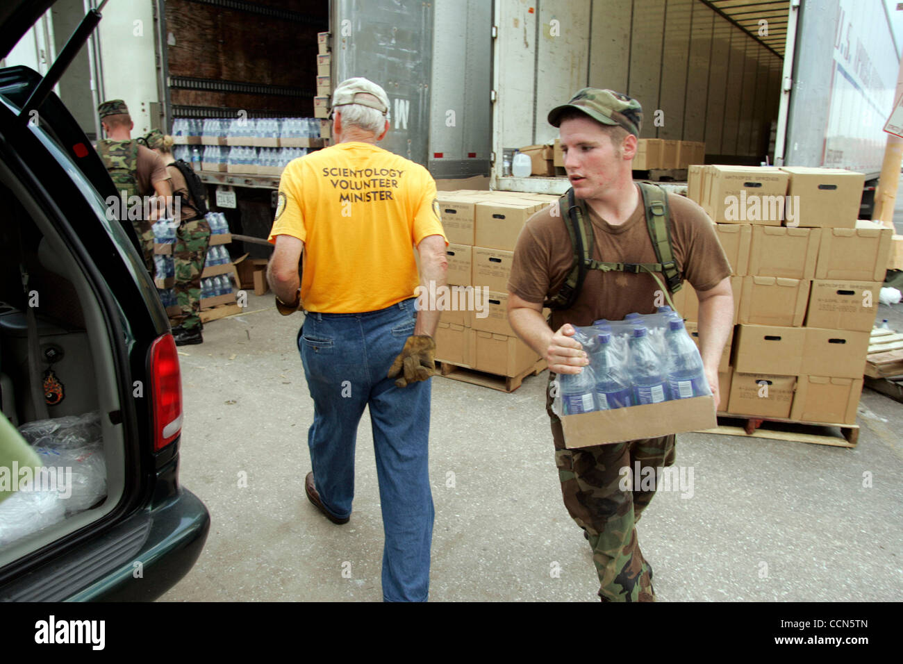 Private Jeff Lefevre of the U.S. National Guard loads a van with a case ...