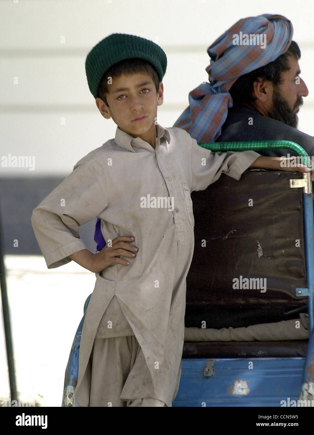 Aug 16, 2004; Kabul, AFGHANISTAN; A young Afghan boy rest in the shade ...