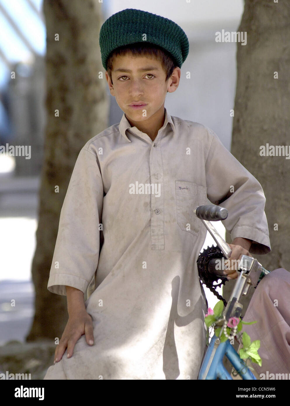 Aug 16, 2004; Kabul, AFGHANISTAN; A young Afghan boy rest in the shade ...