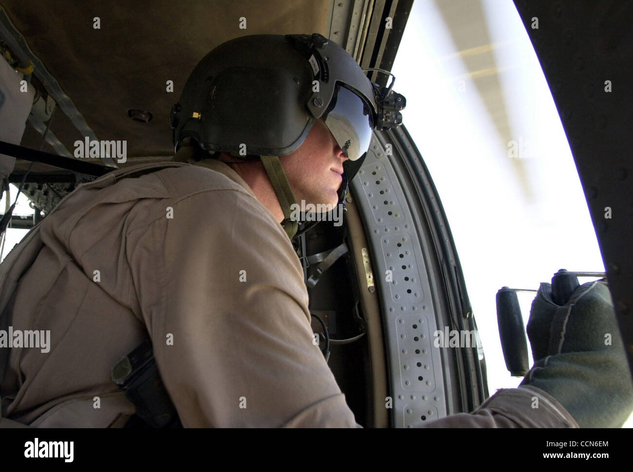 Aug 27, 2004; Kandahar, AFGHANISTAN; A gunner on a Blackhawk helicopter ...
