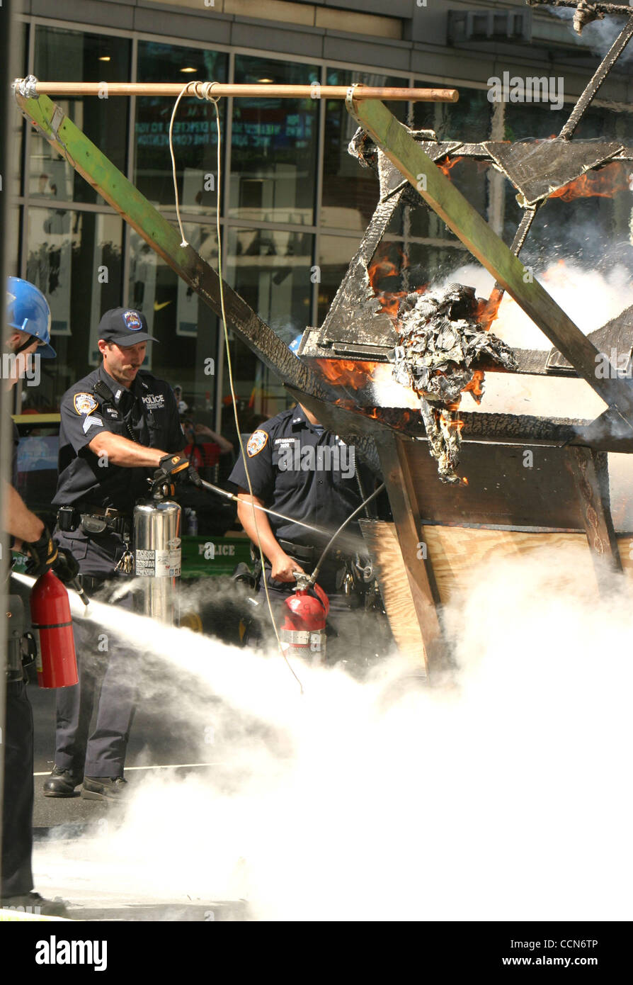 Aug 29, 2004; New York, NY, USA; Police extinguish a float set on fire ...